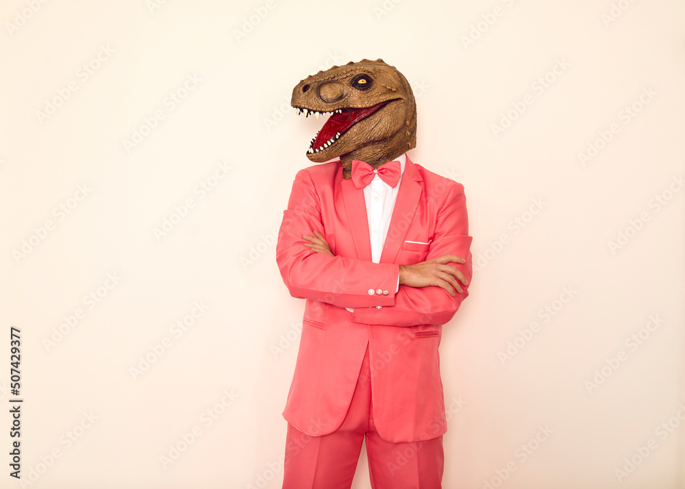 Studio shot of strange guy wearing wacky ugly dinosaur mask. Man in ...