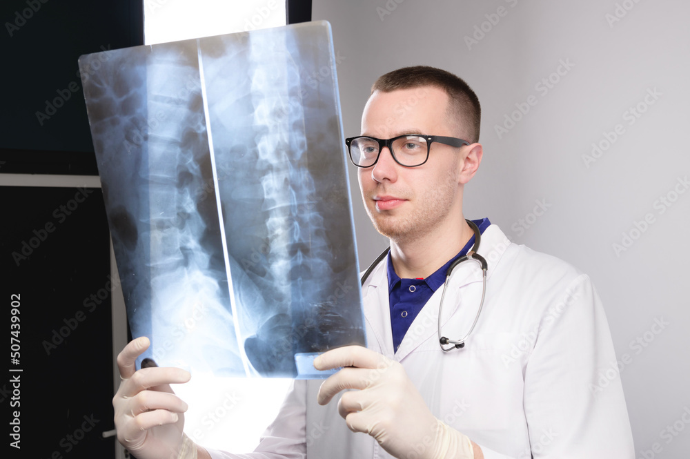 surgeon examines x-ray. spinal x-ray. health problems. nurse checking x ...