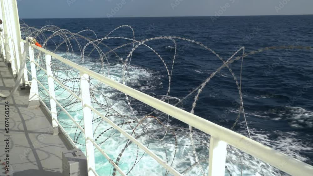 Barbed wire on railing ship. Protection from pirates. Open deck in ...