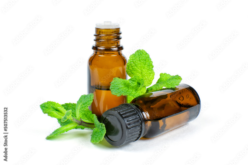Essential oil of fragrant mint (peppermint) in two dark glass bottles ...