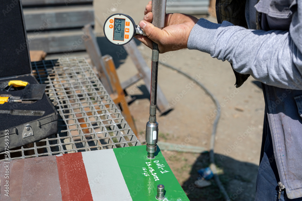 Paint inspector is testing pull-off adhesion (dolly) test for coating ...