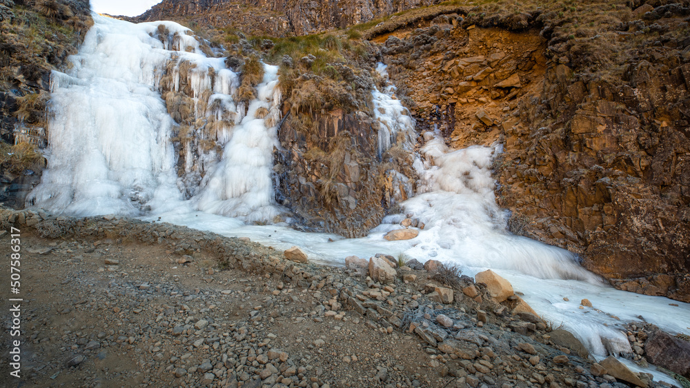 Mountain waterfall frozen at the Sani Pass, Drakensberg Mountains in ...