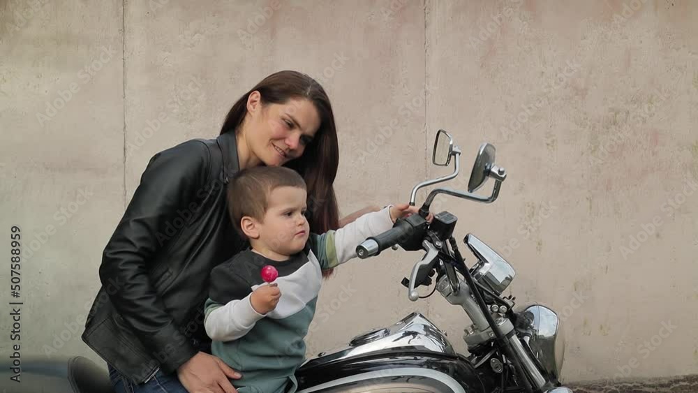 Young Mother Shows Her Son How To Turn On The Buttons On Her Motorcycle ...