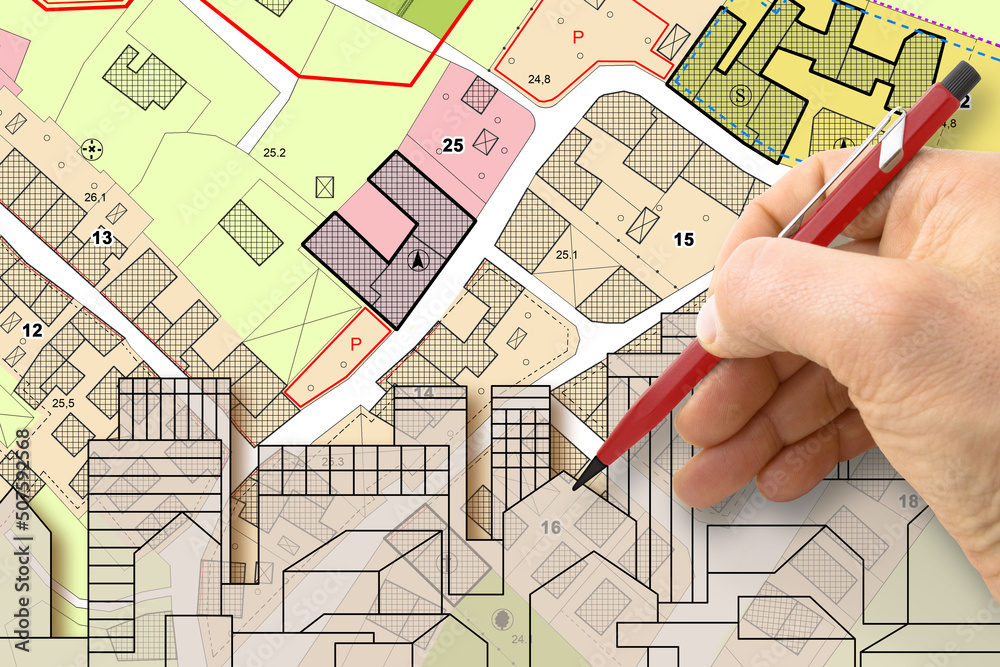 Architect drawing buildings over an imaginary cadastral map of territory and General Urban Plan ...