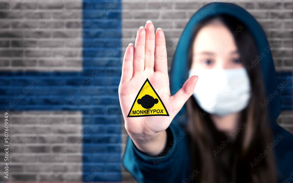 MONKEYPOX. Flag of Finland. A girl in a mask for protection against ...
