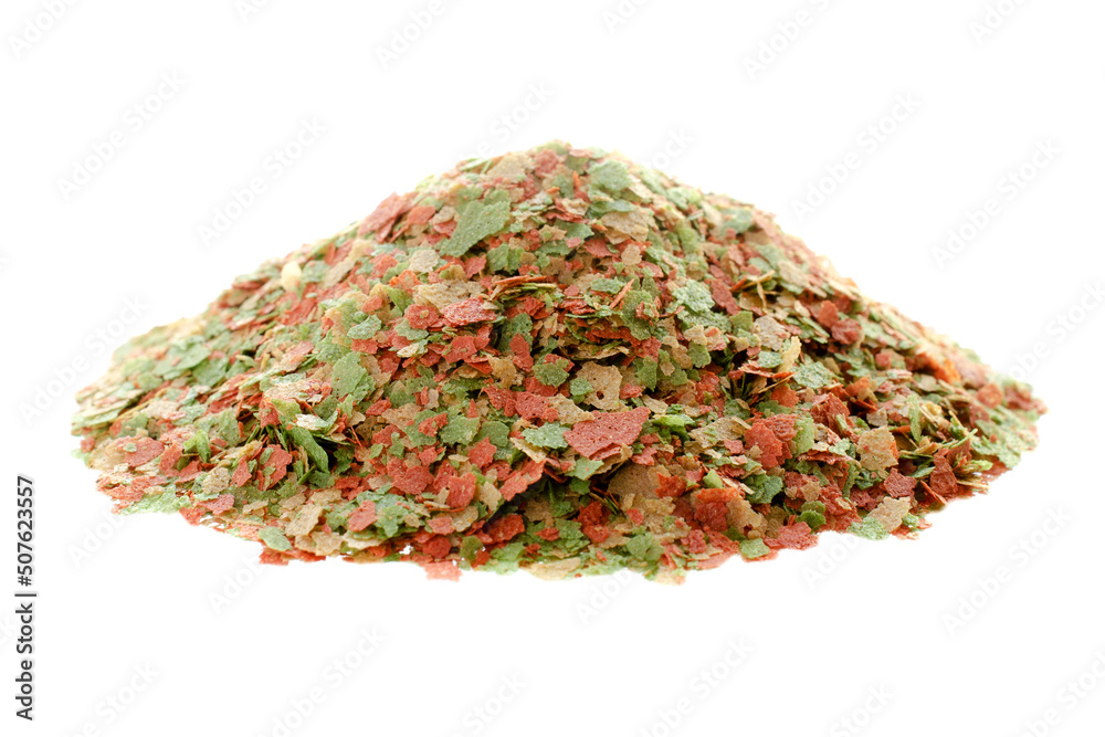 Granular food for aquarium fish isolated on white background. Pile of ...