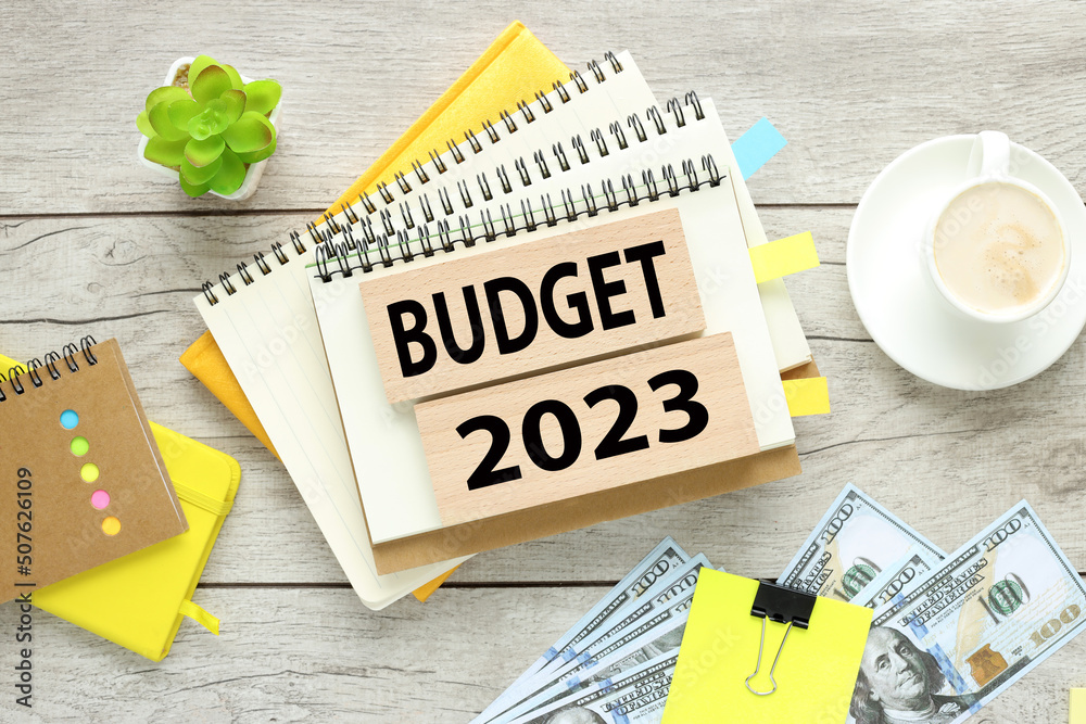 2023 Budget. a lot of notepads on the desktop. A blank sheet of notepad ...