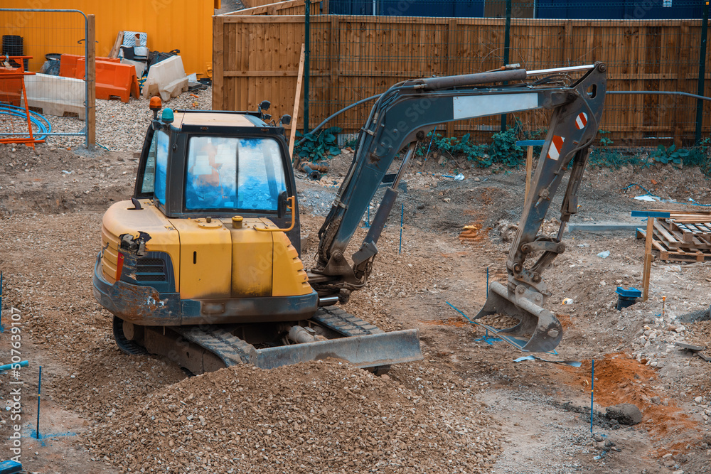 Aerial view of excavator levelling stone during private road ...