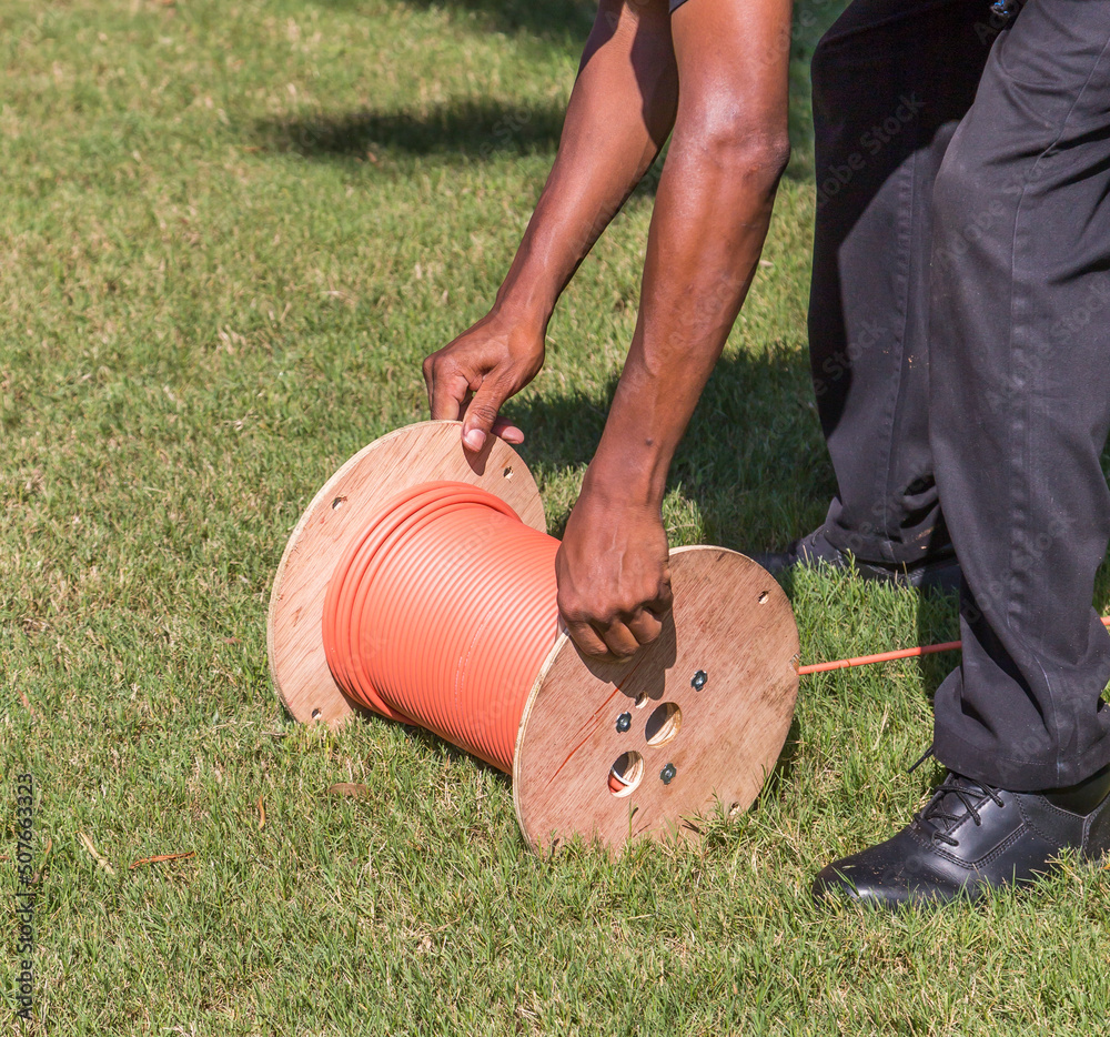 Cable repair man running coaxial internet and video cable to a junction ...