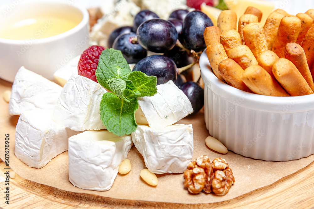 Board with different types of cheese. Cheeses mix set dor blu chedar ...