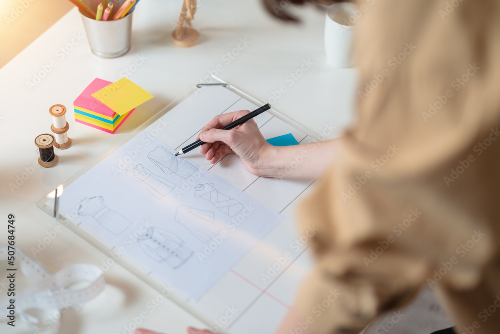 Designer drawing template for sewing new dress according to her ...