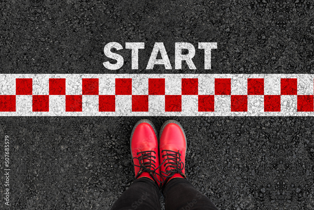 Start. Woman legs in boots standing next to Start line racing Stock ...