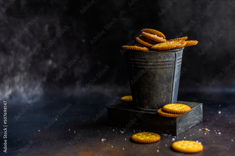 Salted cracker cookies in a metal bucket on a table Stock Photo | Adobe ...