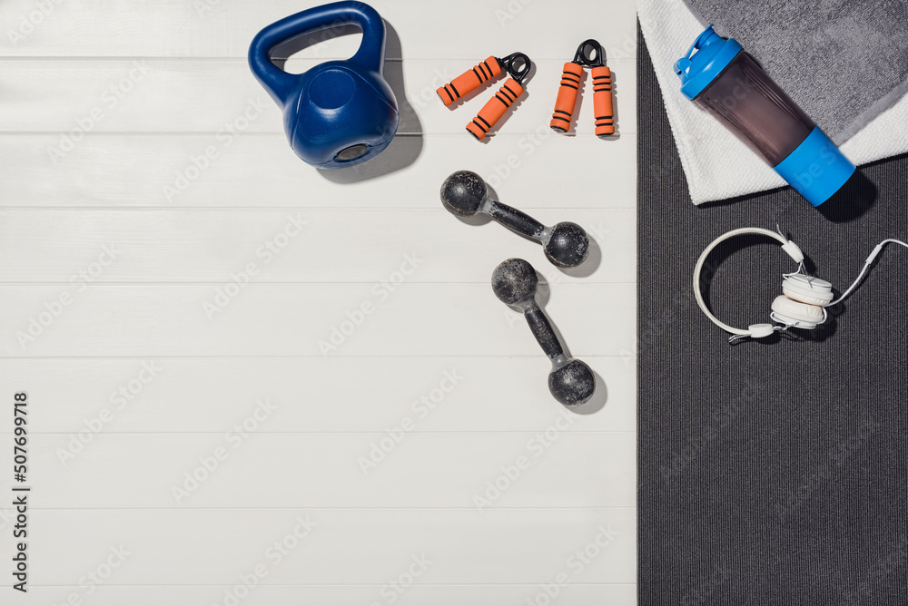 Fitness or bodybuilding concept on white wooden flooor background ...