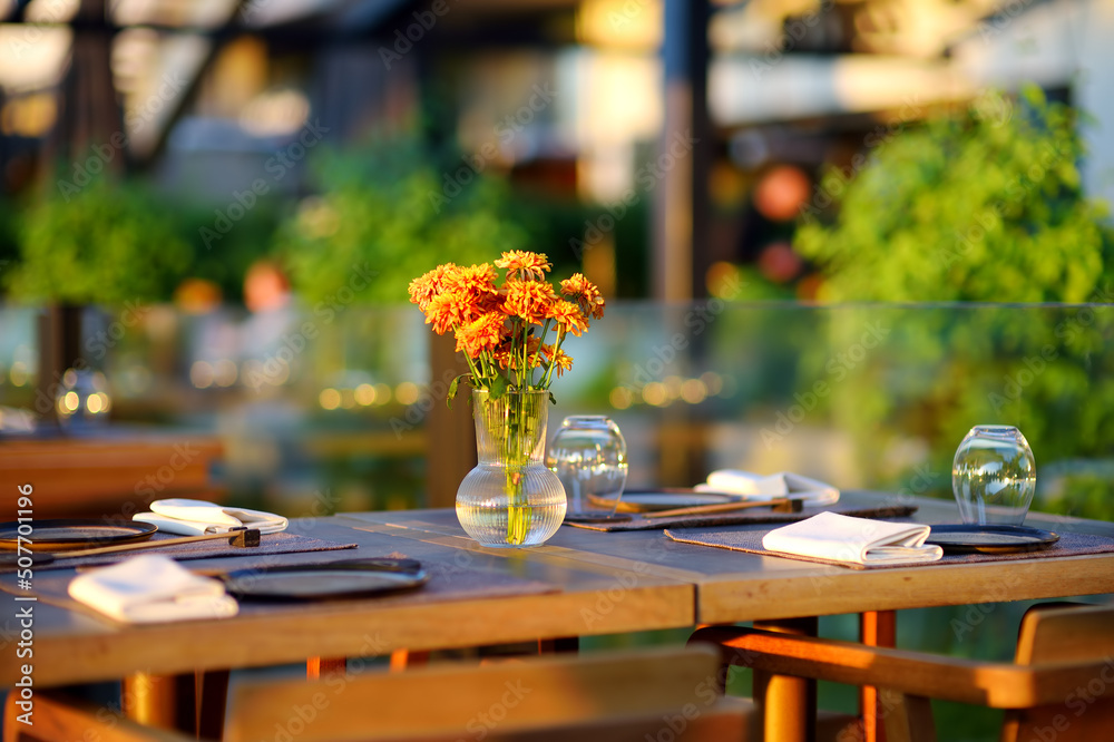 Outdoor cafe on sunny summer day. Stylish table decoration with natural ...