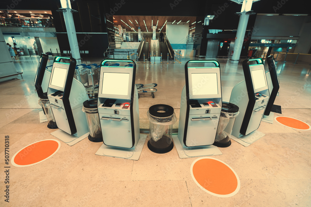 A group of six electronic self-service chek-in, luggage drop, and ...