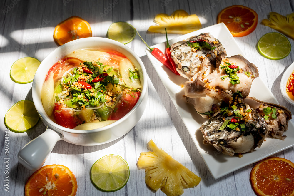 Vietnamese family food. Sour soup bowl of snakehead fish is rich in ...