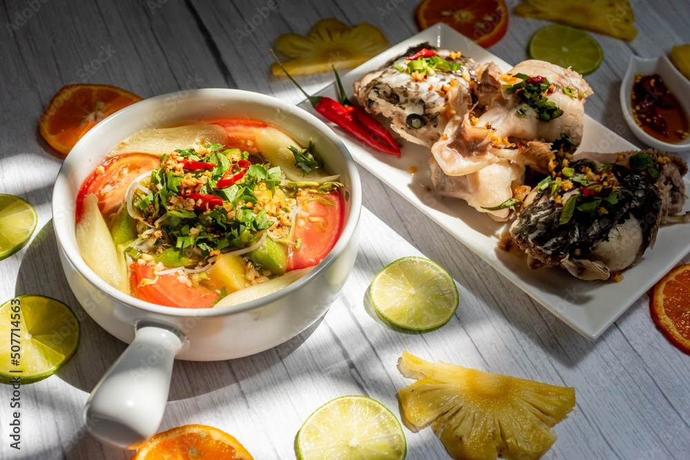 Vietnamese family food. Sour soup bowl of snakehead fish is rich in ...