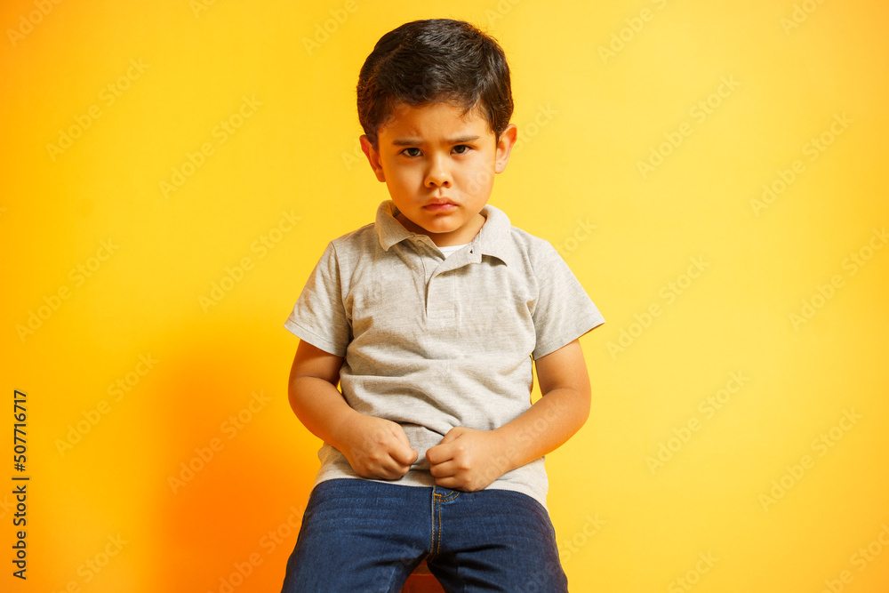 angry boy sitting on a bench Stock Photo | Adobe Stock