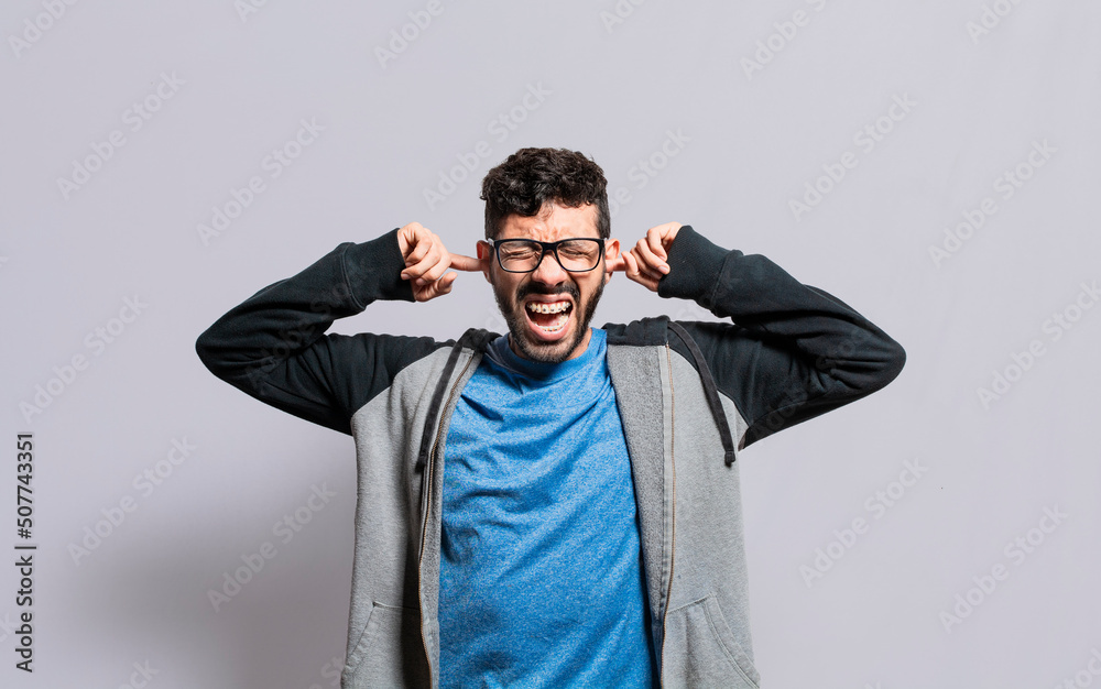 Irritated person screaming covering his ears, desperate person avoiding ...