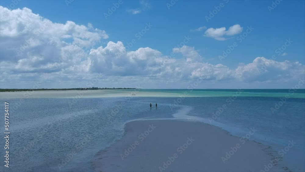 Arial footage of a sandbar in the shallow blue turquoise water of a ...
