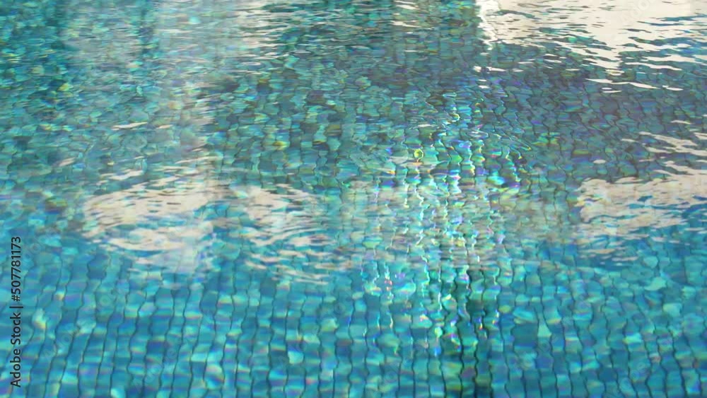 Blue sunny bottom of swimming pool transparents through rippling ...