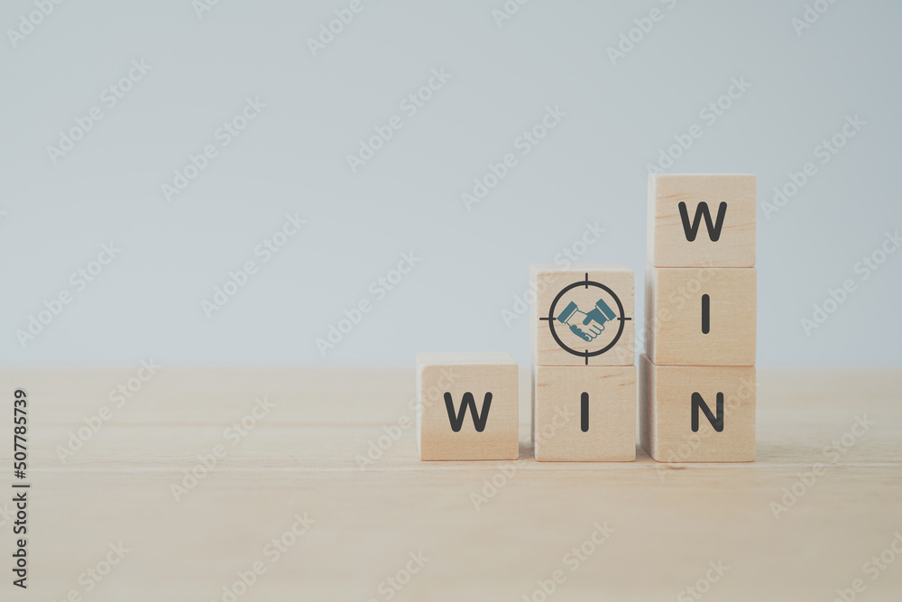 handshake icon in focus sign and win win text on wooden cube blocks ...