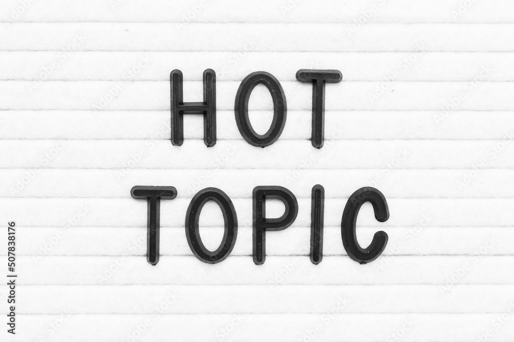 Black color letter in word hot topic on white felt board background ...