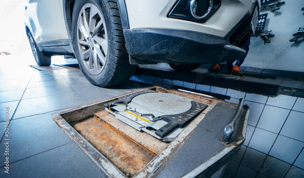 CLose-up wheel of car in auto service maintenance repair center before ...