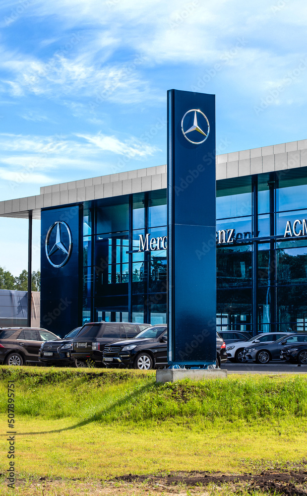 Mercedes-Benz dealership with a modern facade and cars on display in ...