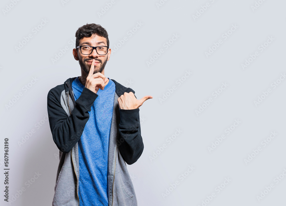 Mysterious person pointing to the side with his fingers on isolated ...