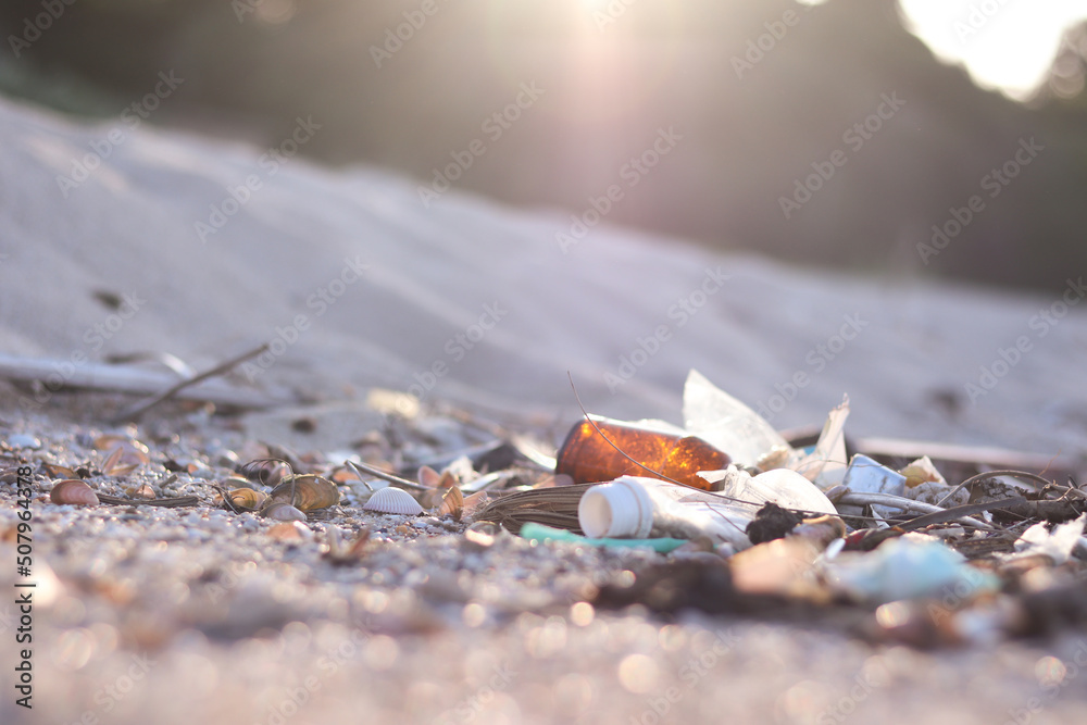 Beach pollution. Plastic bottles and other trash on sea beach ...