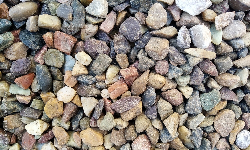 A closeup of a pile of loose rough stones taken at a stone pit. The ...