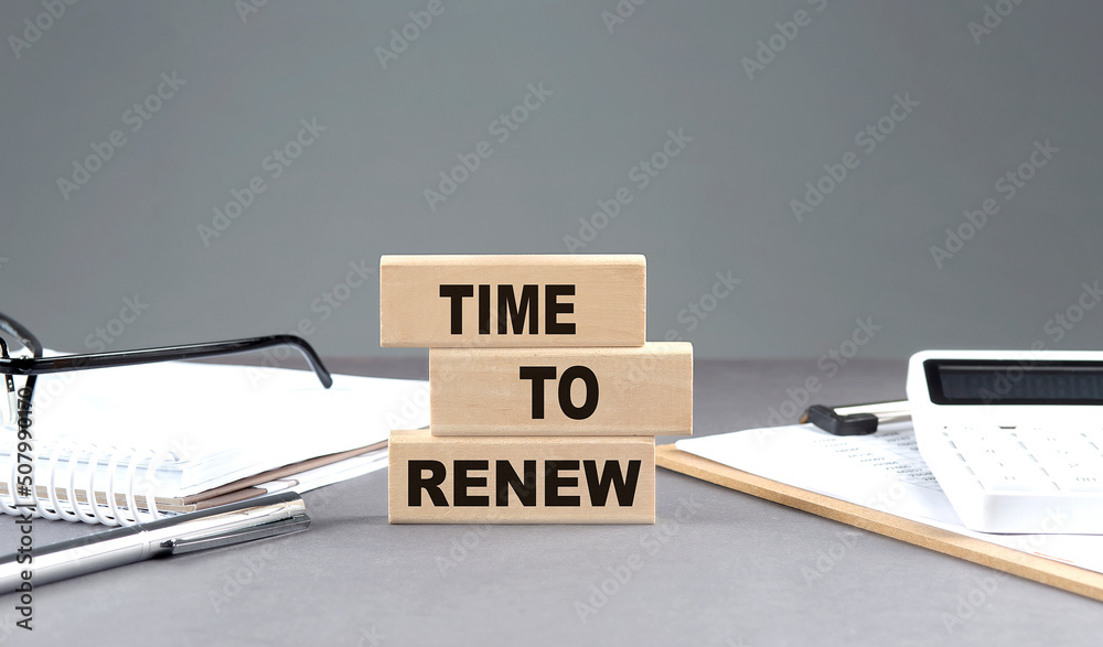 TIME TO RENEW text on wooden block with notebook,chart and calculator ...