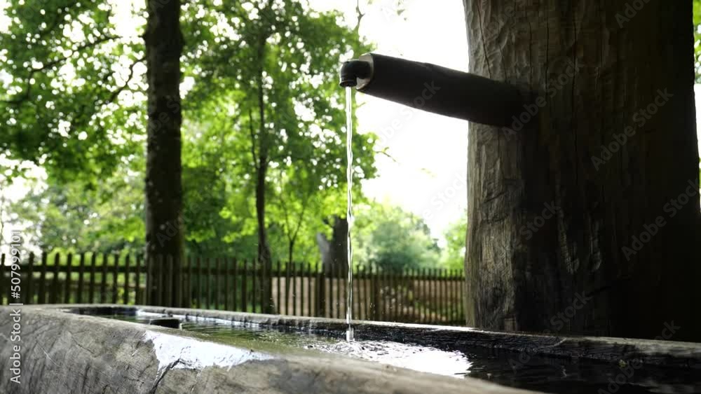 Clean drinking water flowing down in slow motion from a public water ...