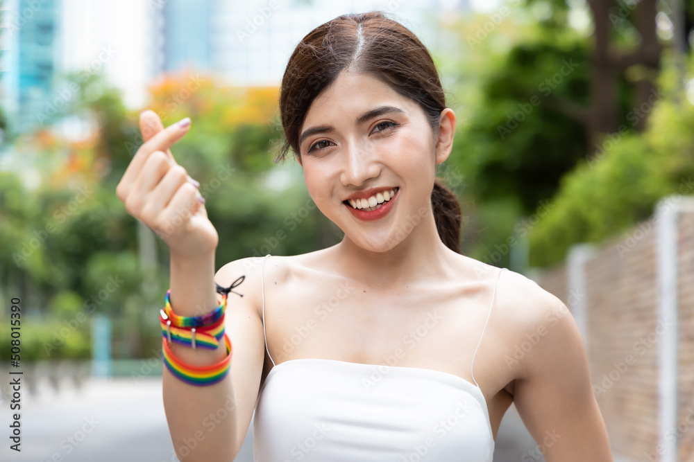 Non-binary LGBT person showing loving heart hand sign for LGBT ...