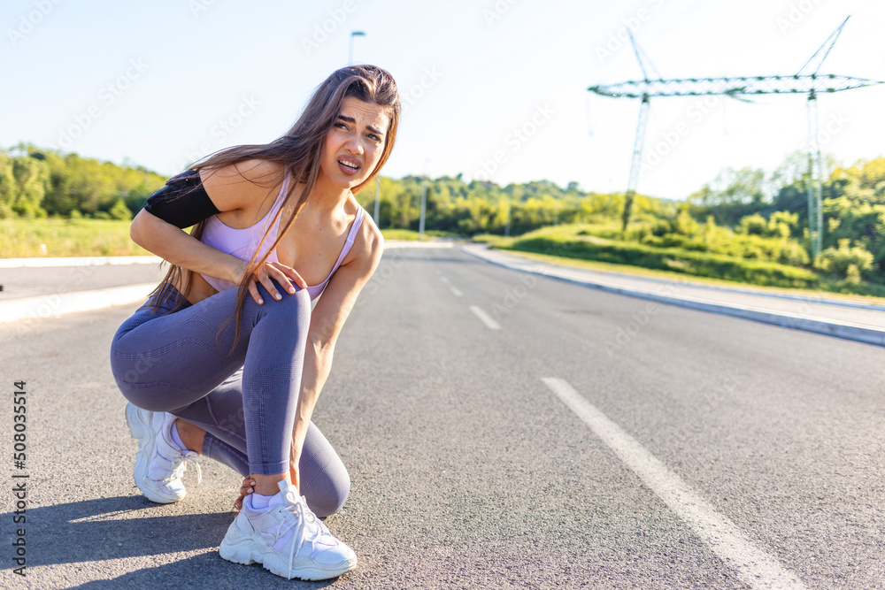 Young sports women having pain / injury during exercise and jogging in ...