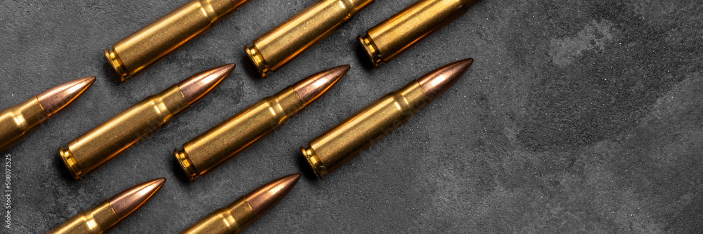 Bullets on gray background banner with copy space. Cartridges 7.62 ...