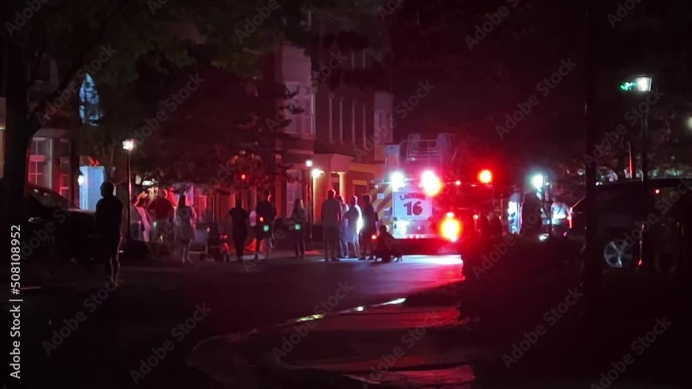 Fire truck emergency vehicles with flashing lights at night at a ...