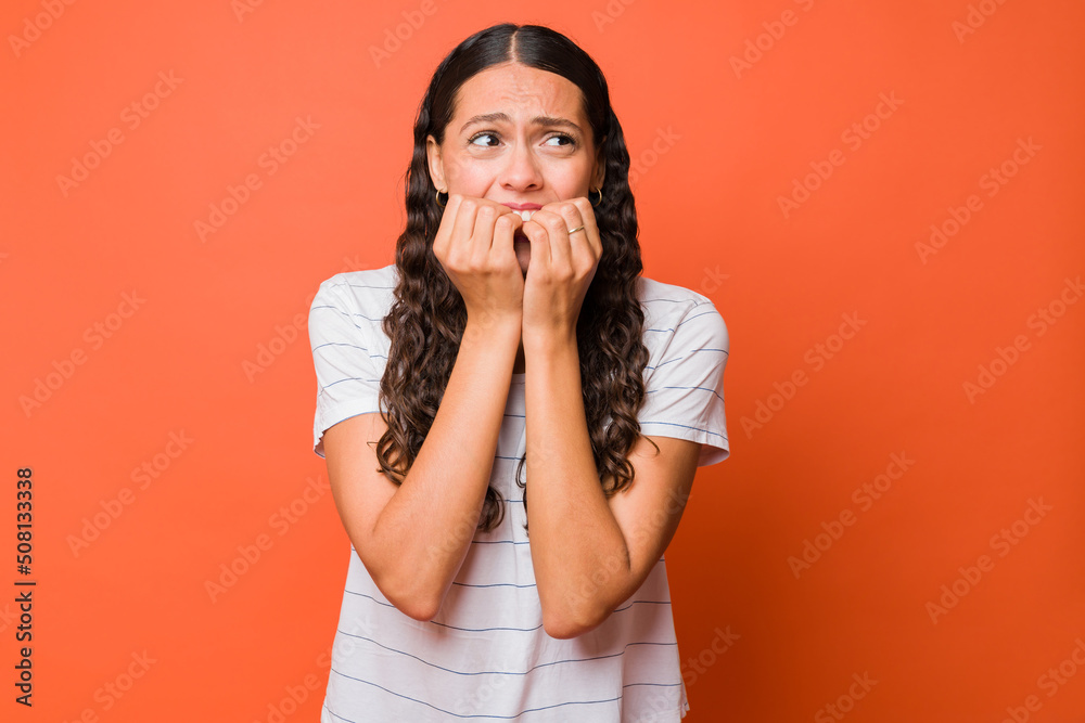 Fearful woman watching something scary Stock Photo | Adobe Stock