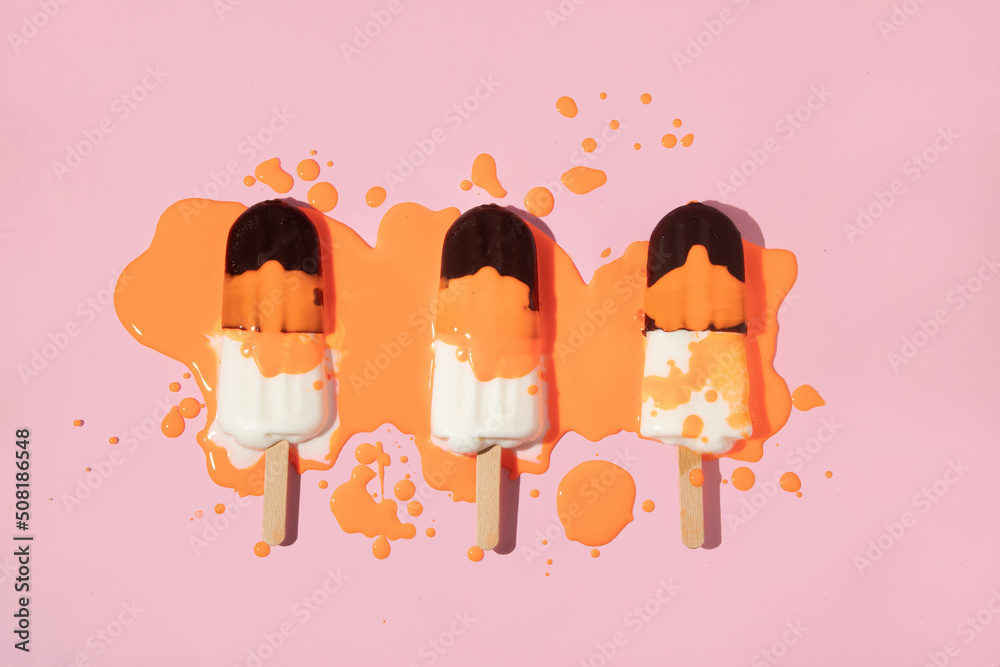 Summer creative layout with three ice cream popsicles and neon orange ...