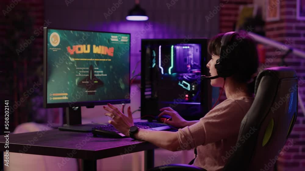 Gamer girl celebrating winning first place in space shooter online ...