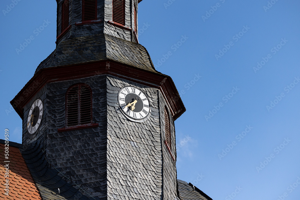 Church clock. Close up church tower with roff shingles. Ancient clock ...