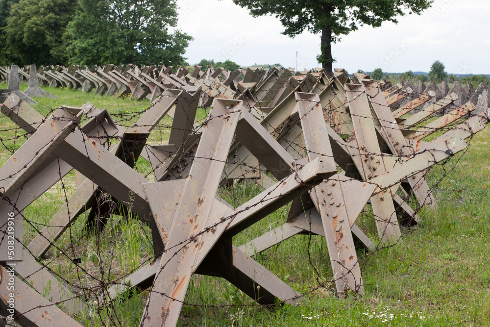 Hedgehod anti-tank barrier with barbed wire Stock Photo | Adobe Stock