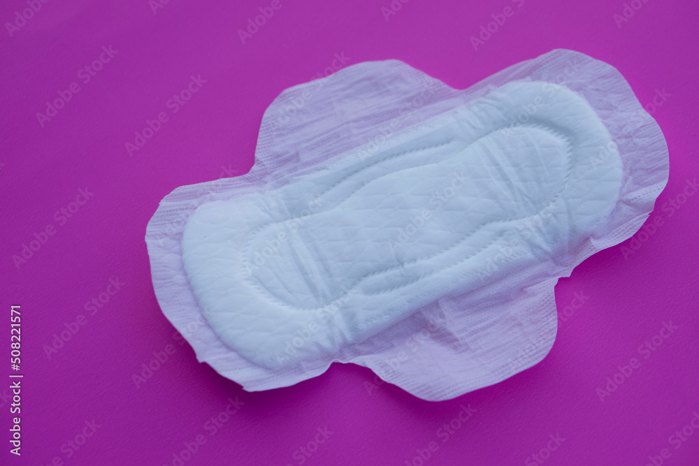 White sanitary pad on pink background. Concept: female's hygienic ...