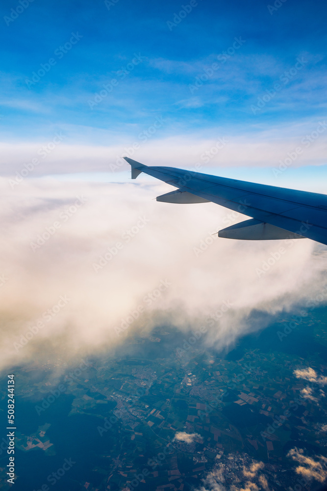 Flying and traveling, view from airplane window on the wing on sunset ...