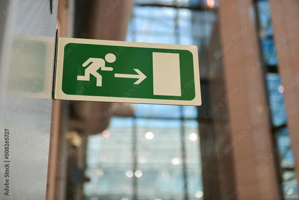 Emergency exit sign inside a conference building. Detail photo of the ...