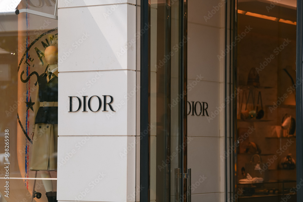 The logo sign of a Dior store in Belgium. Dior is a premium luxury ...