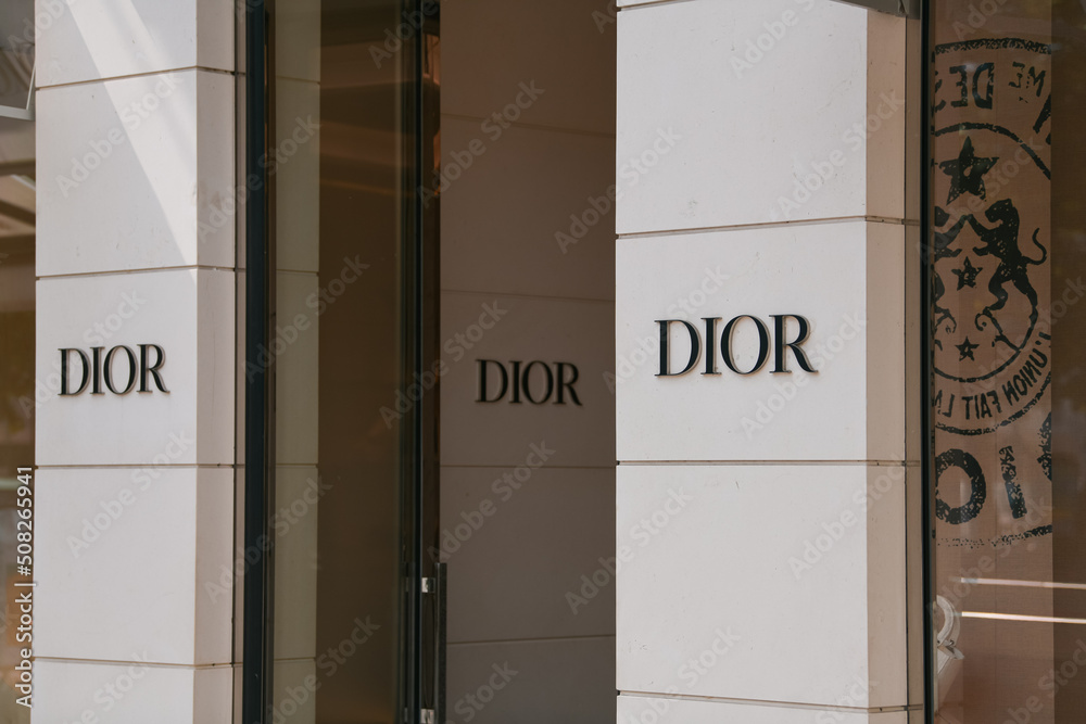 The logo sign of a Dior store in Belgium. Dior is a premium luxury ...