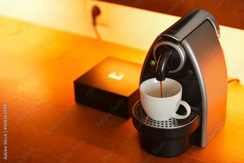 Nespresso Essenza coffee machine preparing an espresso coffee on a ...